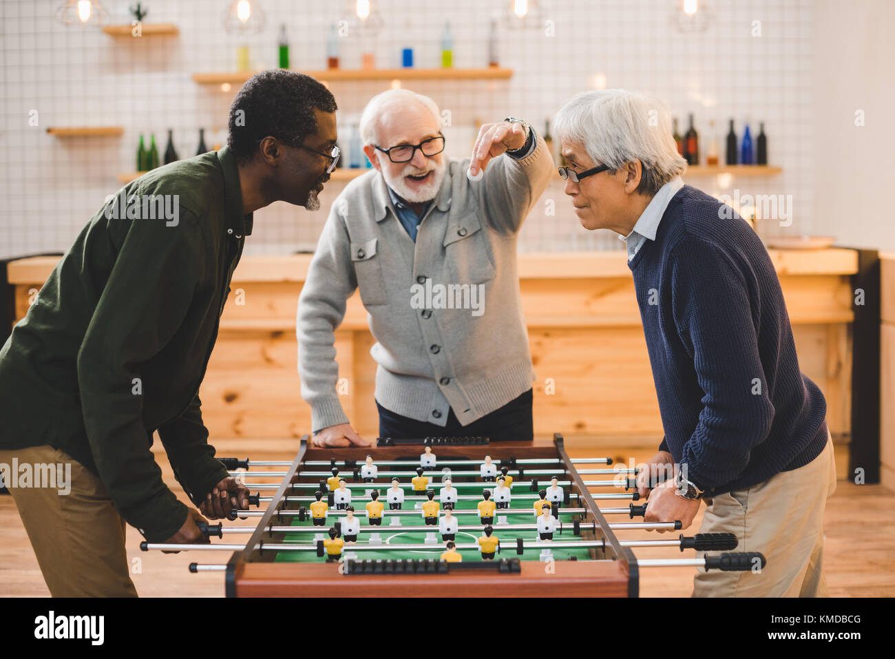 senior friends playing table football Stock Photo - Alamy