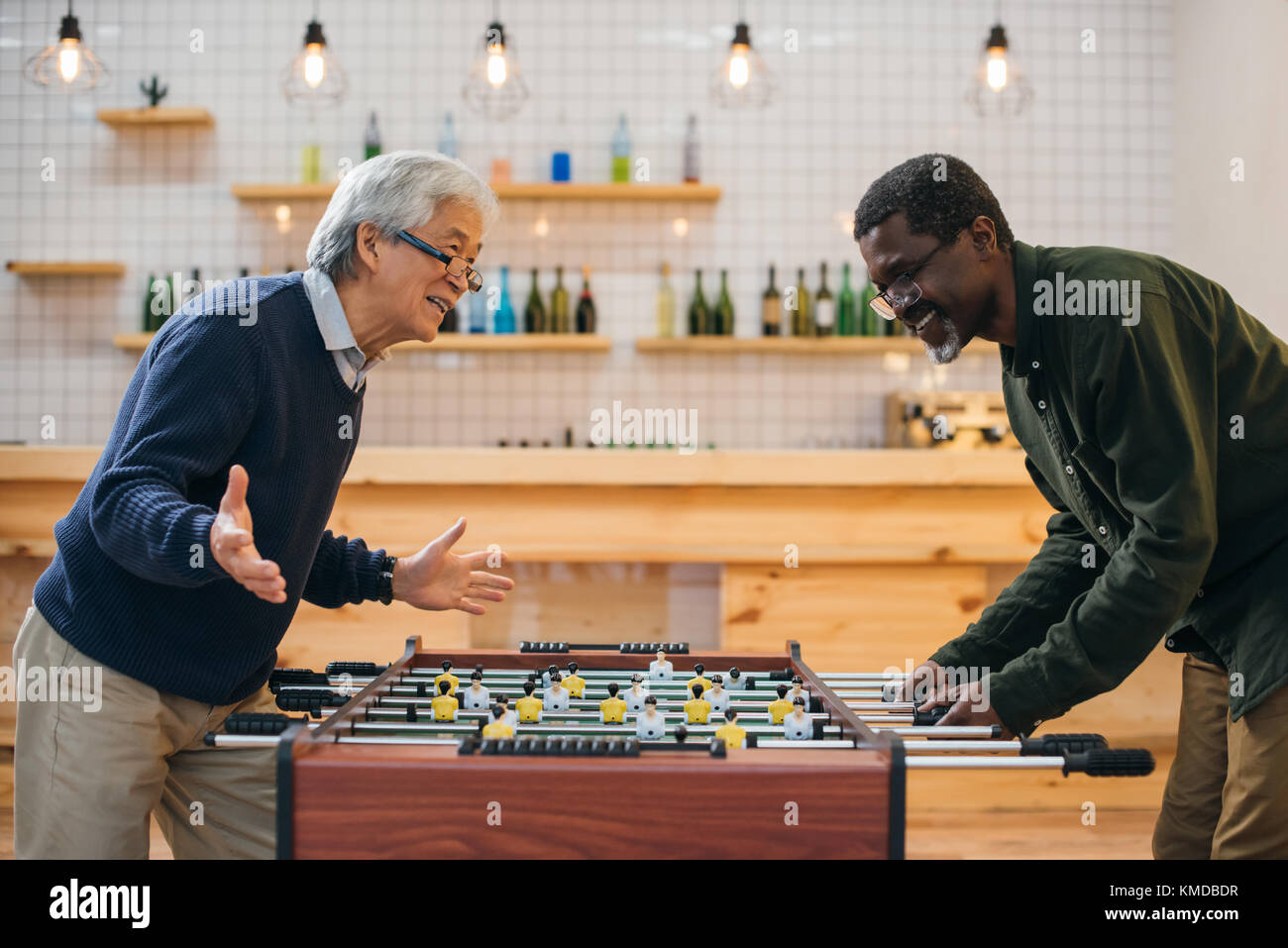 senior friends playing table football Stock Photo - Alamy