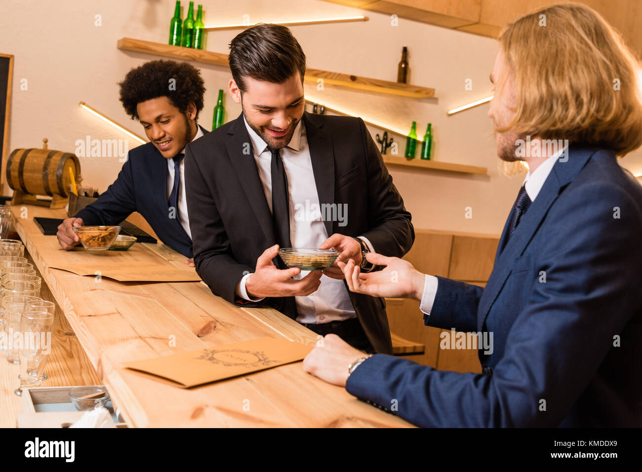 businessmen eating snack in bar Stock Photo - Alamy