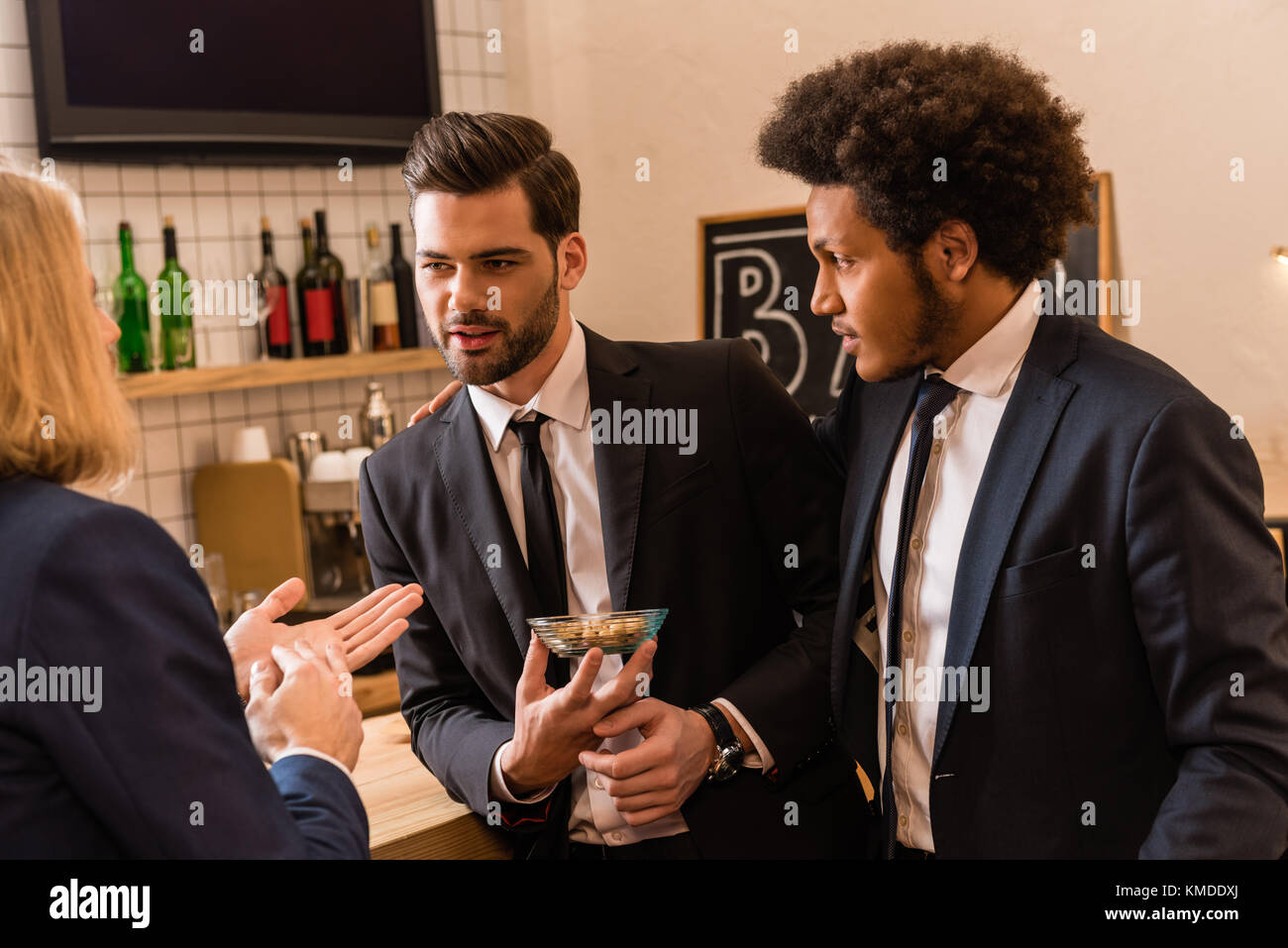 businessmen eating snack in bar Stock Photo - Alamy