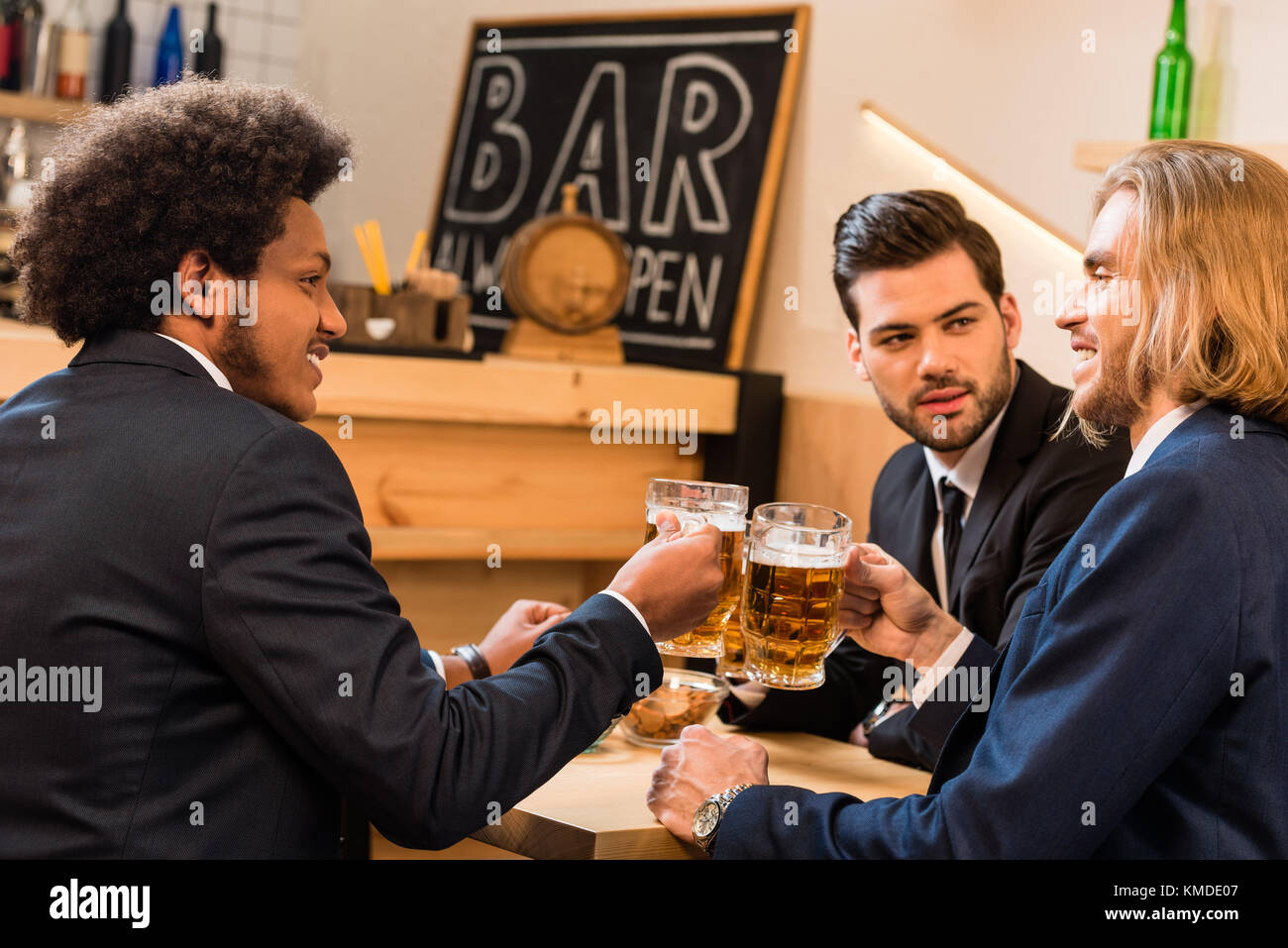 businessmen drinking beer in bar Stock Photo - Alamy