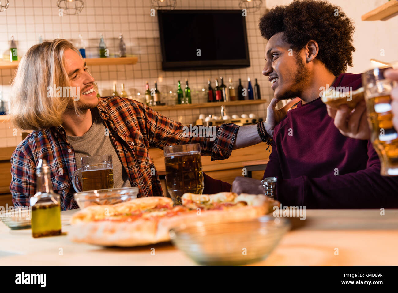 friends drinking beer in bar Stock Photo - Alamy