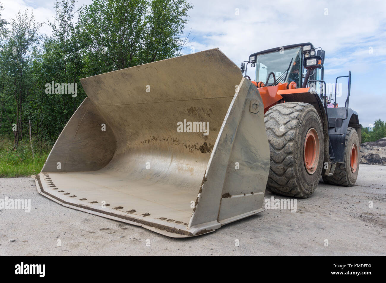 Wheeled loader with a large scoop. Use in construction to move aside or ...