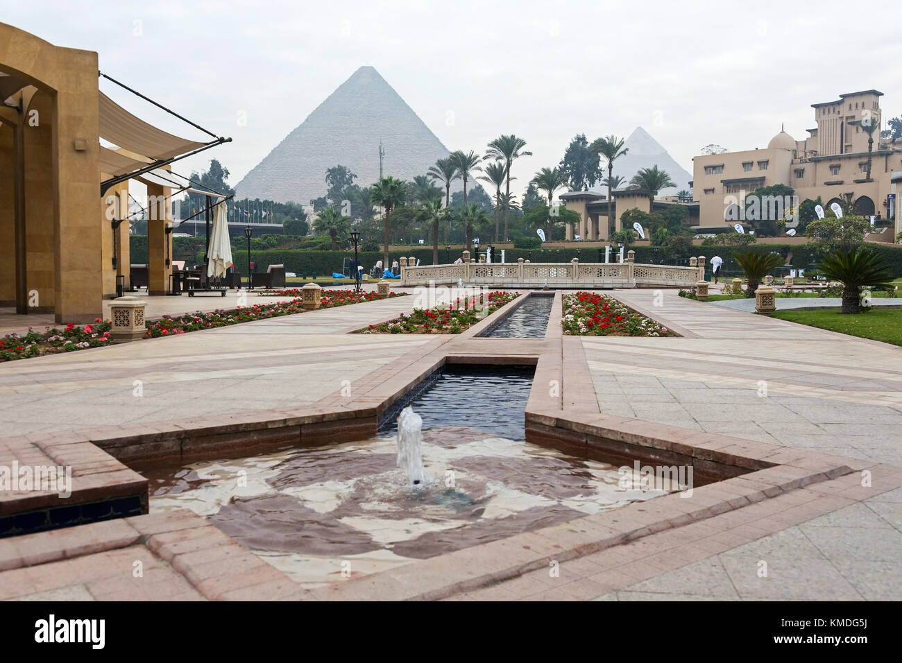 The Pyramids in the background at the pool of the Mena House Hotel ...