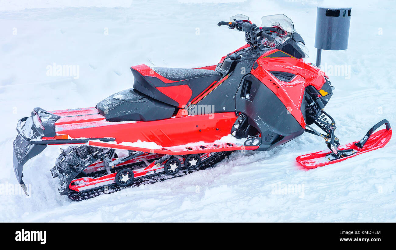 Red snowmobile at frozen lake at winter Rovaniemi, Lapland, Finland ...