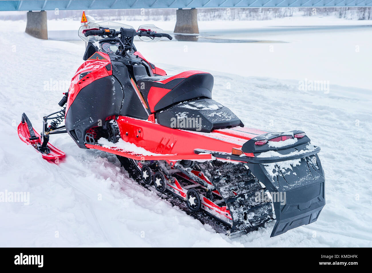 Red snowmobile on frozen lake at winter Rovaniemi, Lapland, Finland ...