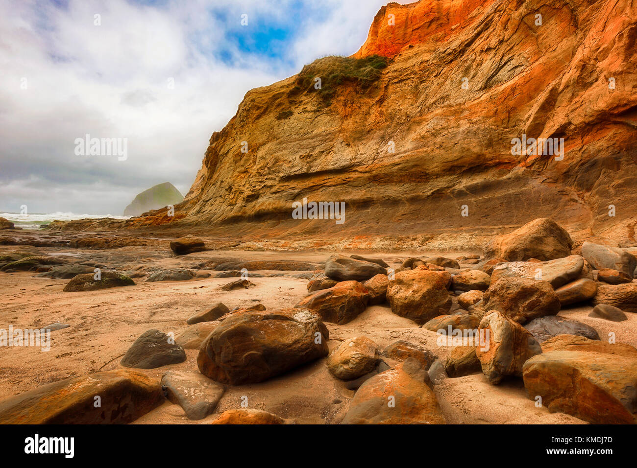 Large rocks fallen from the sandstone cliff at Cape Kiwanda, litter the ...