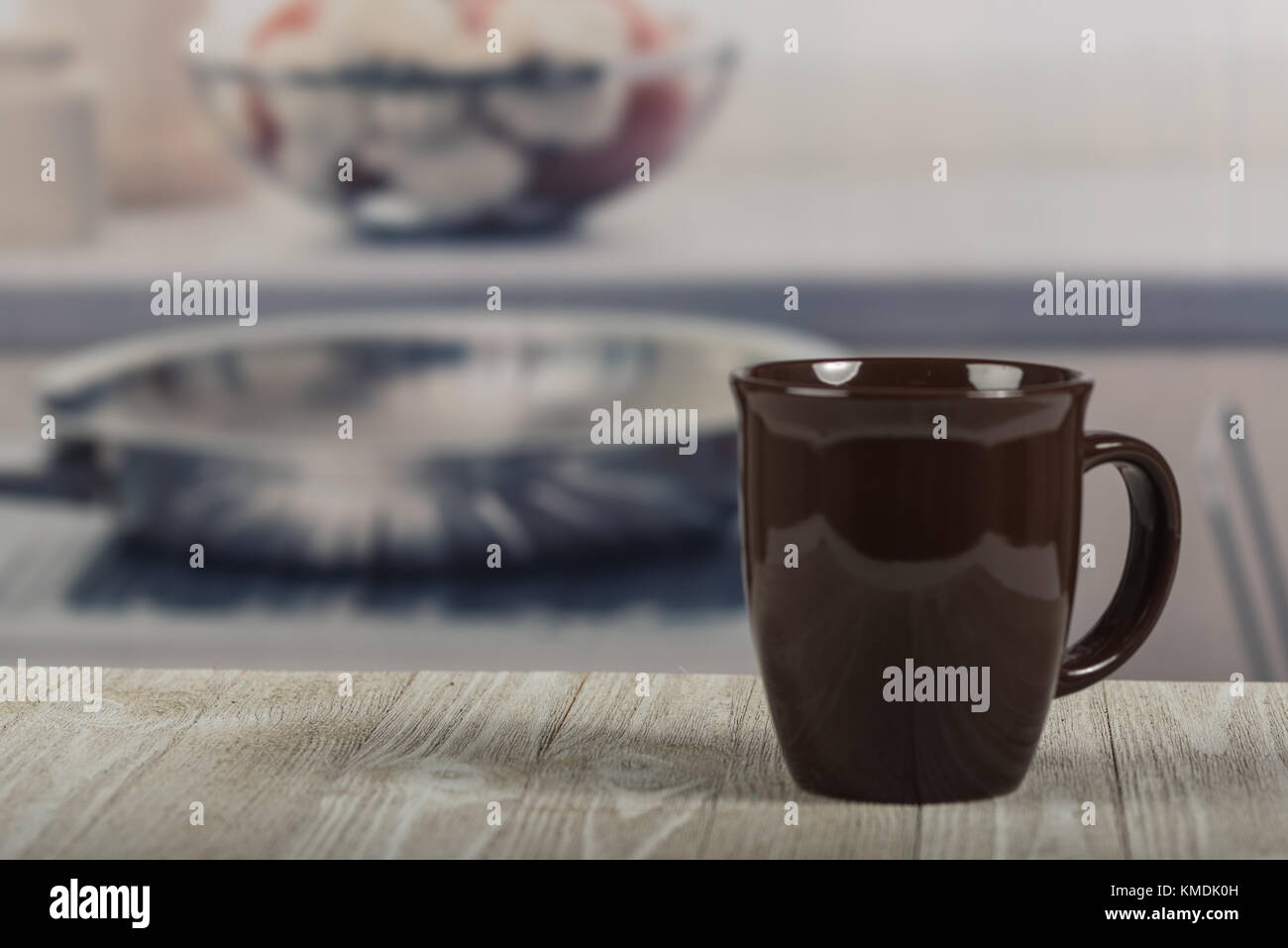 Brown coffee cup on table with kitchen background Stock Photo - Alamy
