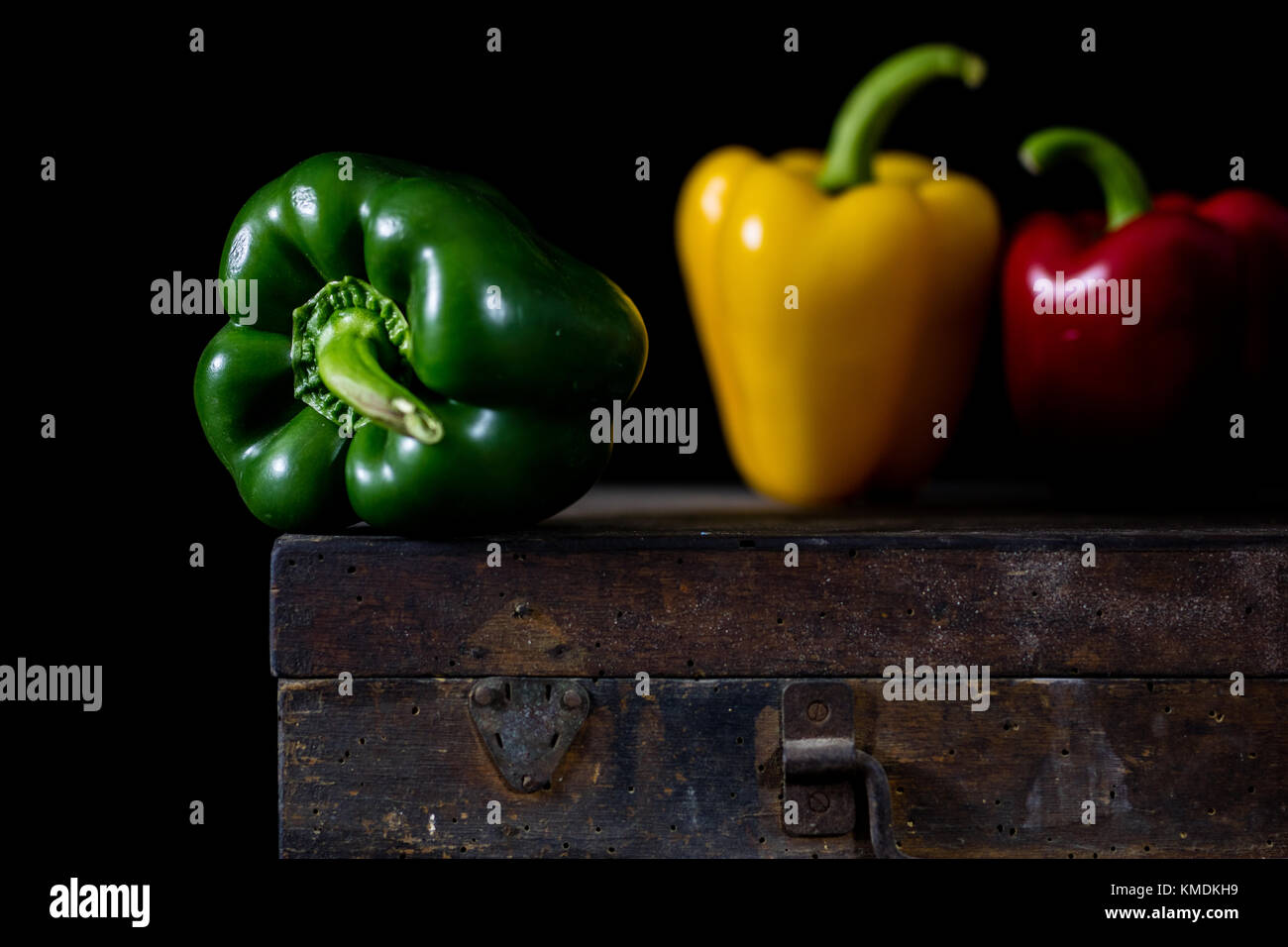Paprika on an old wooden box. Vegetable on an old box. Black background ...