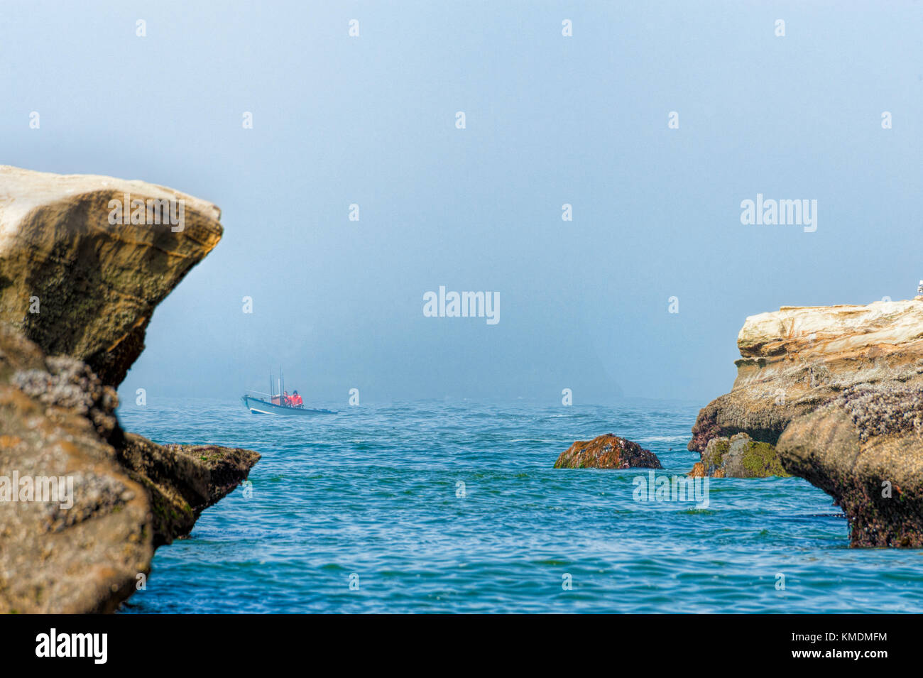 Pacific City, Oregon, USA - July 2, 2015: Haystack Rock shrouded by fog ...