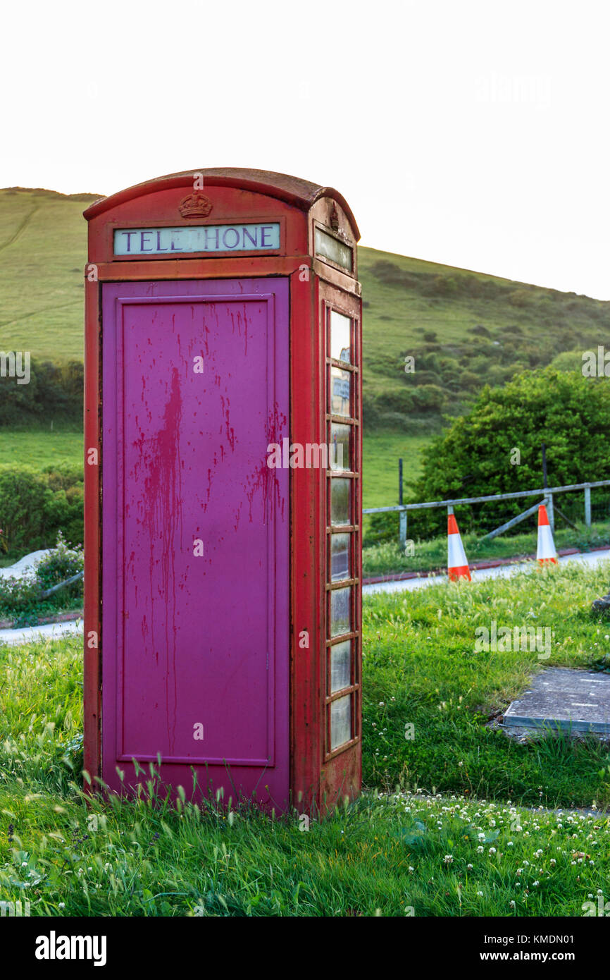 A weathered traditional red British K6 telephone box, designed by Sir Giles Gilbert Scott, at ...