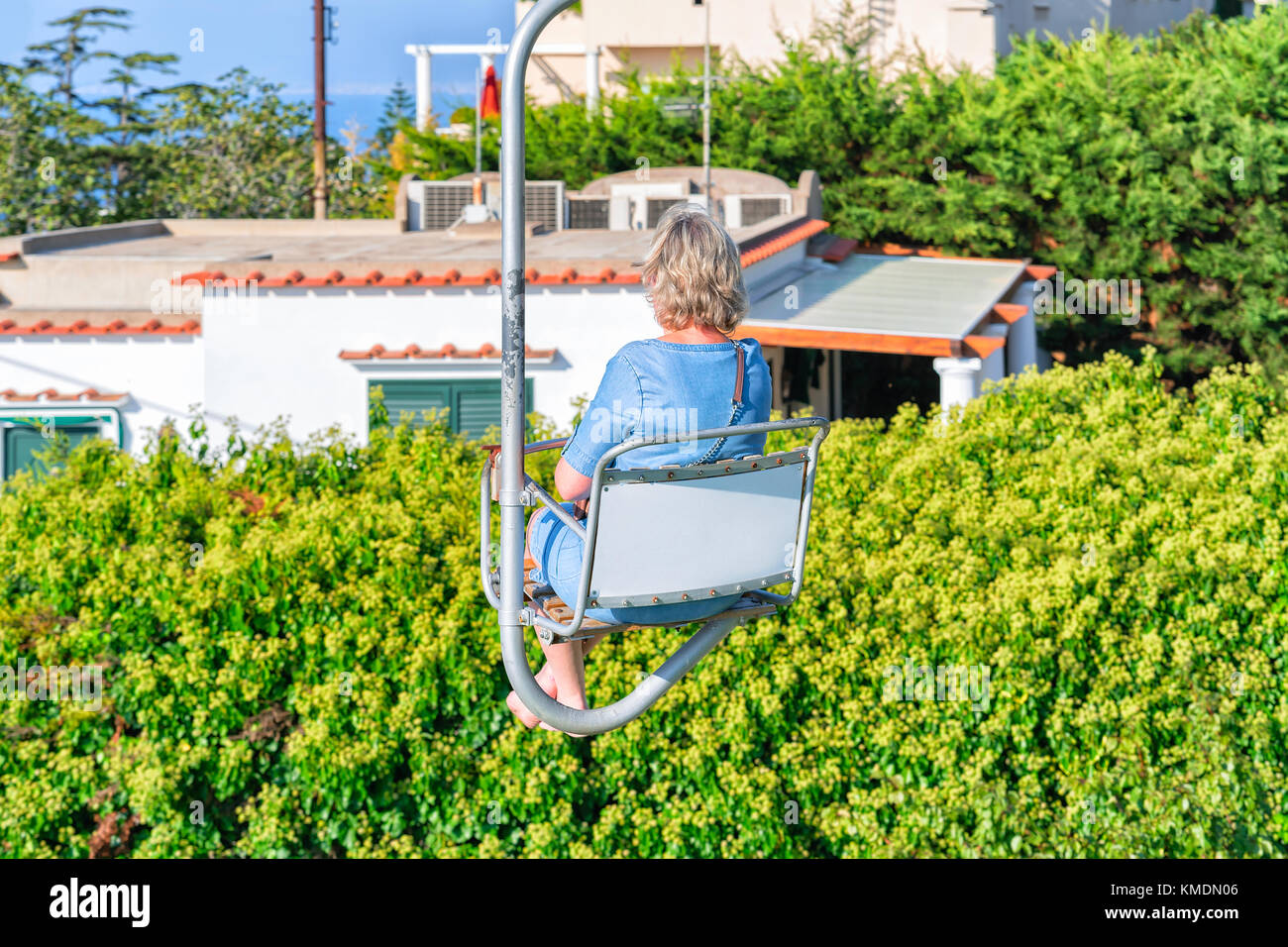 Woman on funicular cable chair above Capri Island, Italy Stock Photo ...