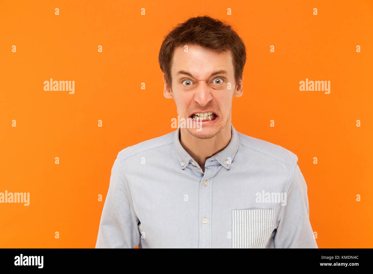 Anger man with big eyes looking at camera. Studio shot Stock Photo - Alamy