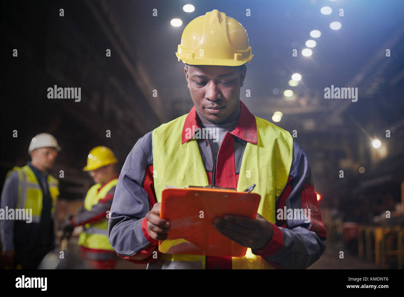 Steelworker with clipboard working in steel mill Stock Photo - Alamy