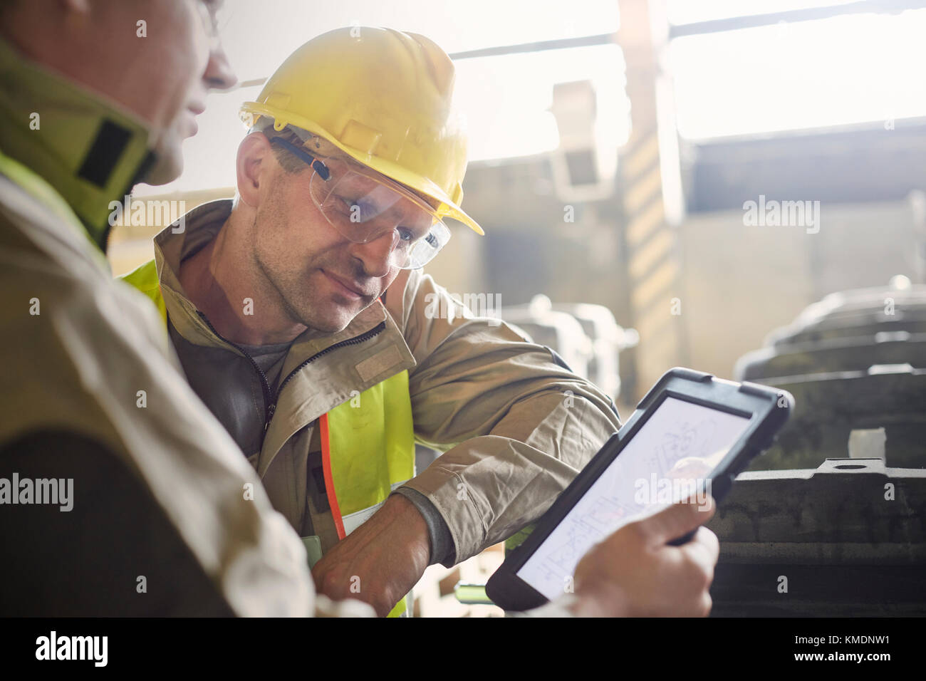 Steelworkers using digital tablet in steel mill Stock Photo - Alamy