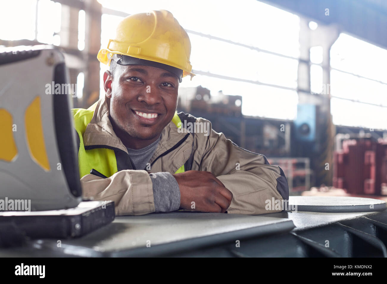 Portrait smiling,confident steelworker at laptop in steel mill Stock ...