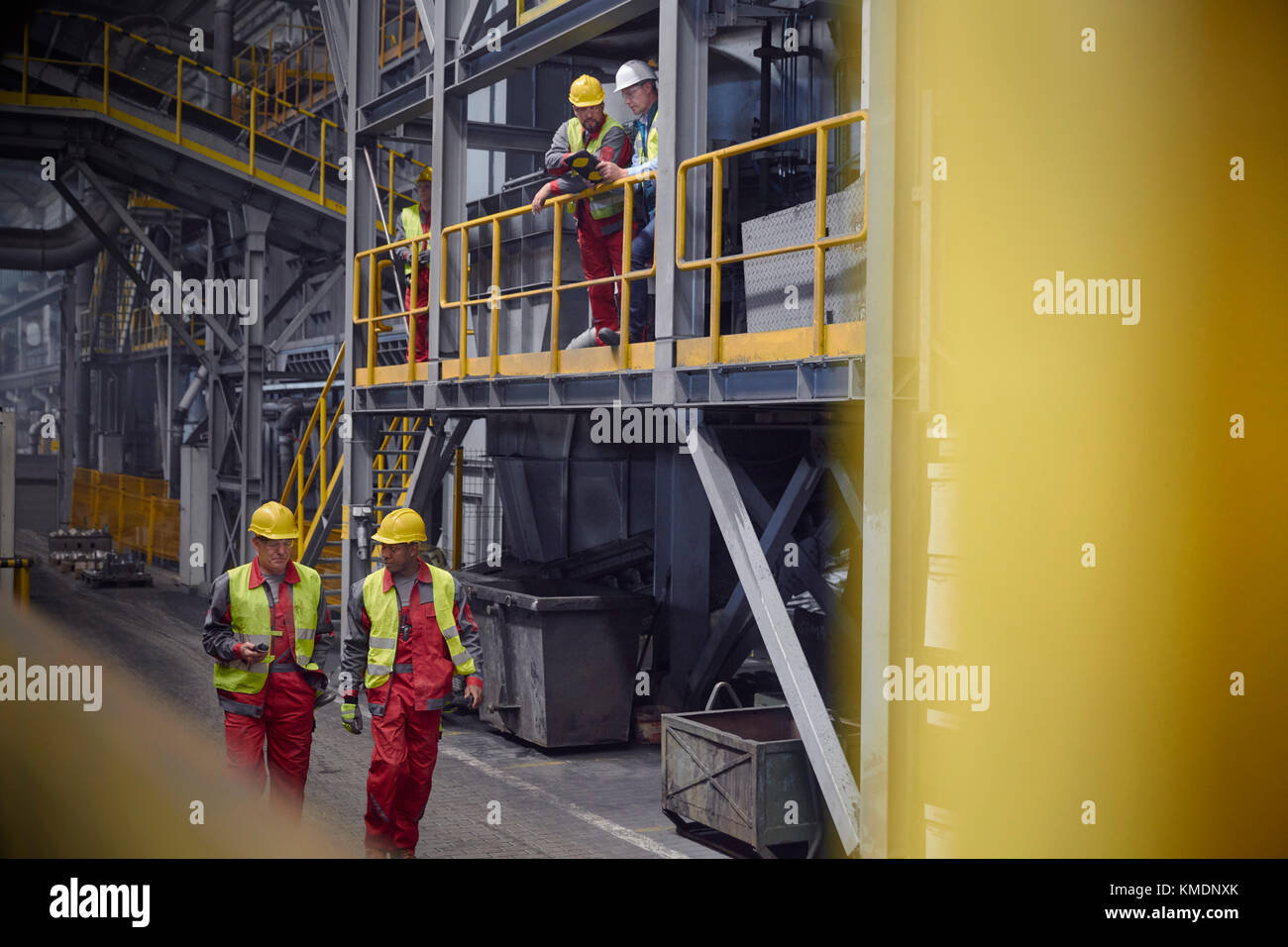 Steelworkers talking and walking in steel mill Stock Photo - Alamy