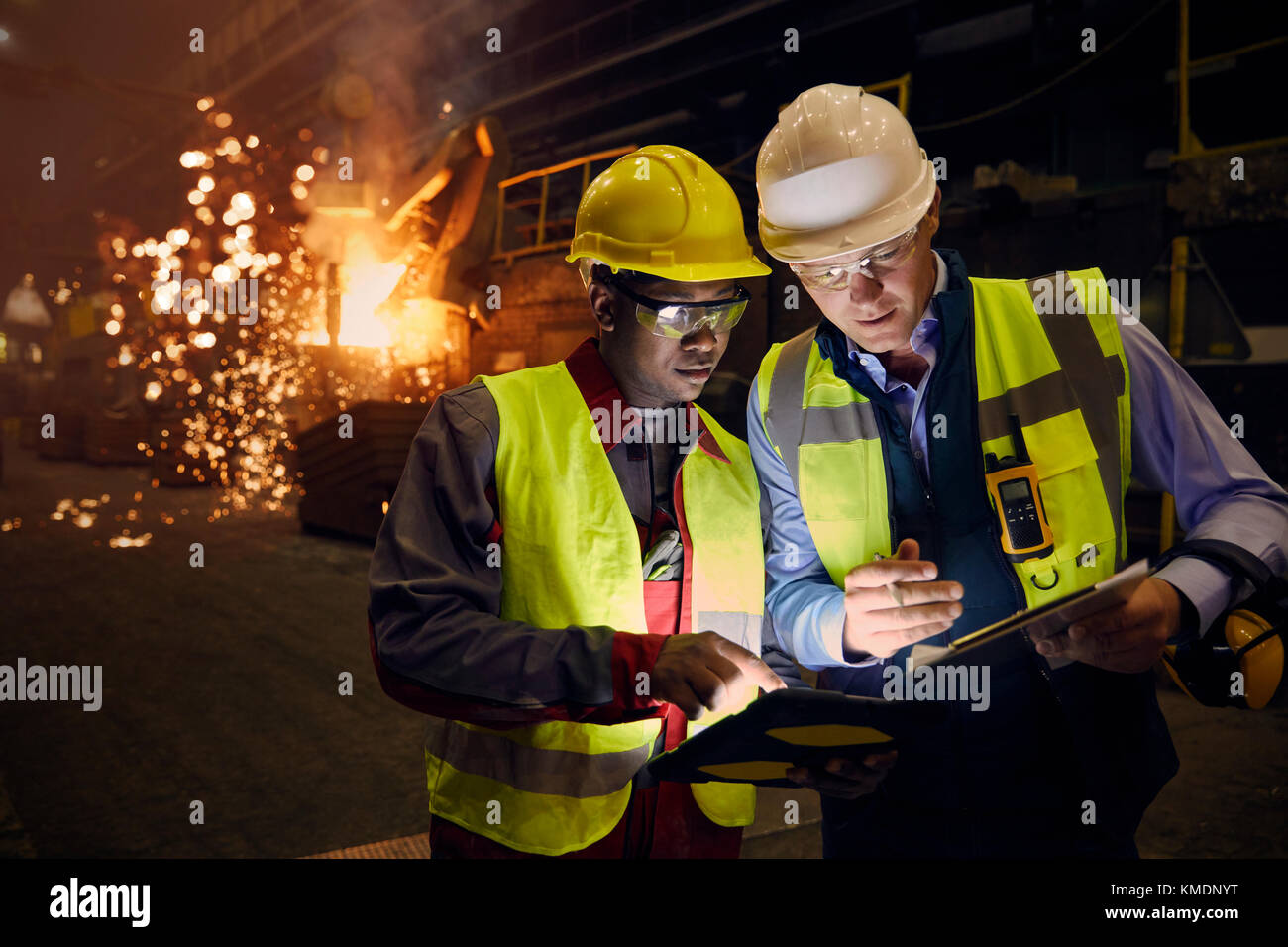 Steelworkers using digital tablets in steel mill Stock Photo - Alamy