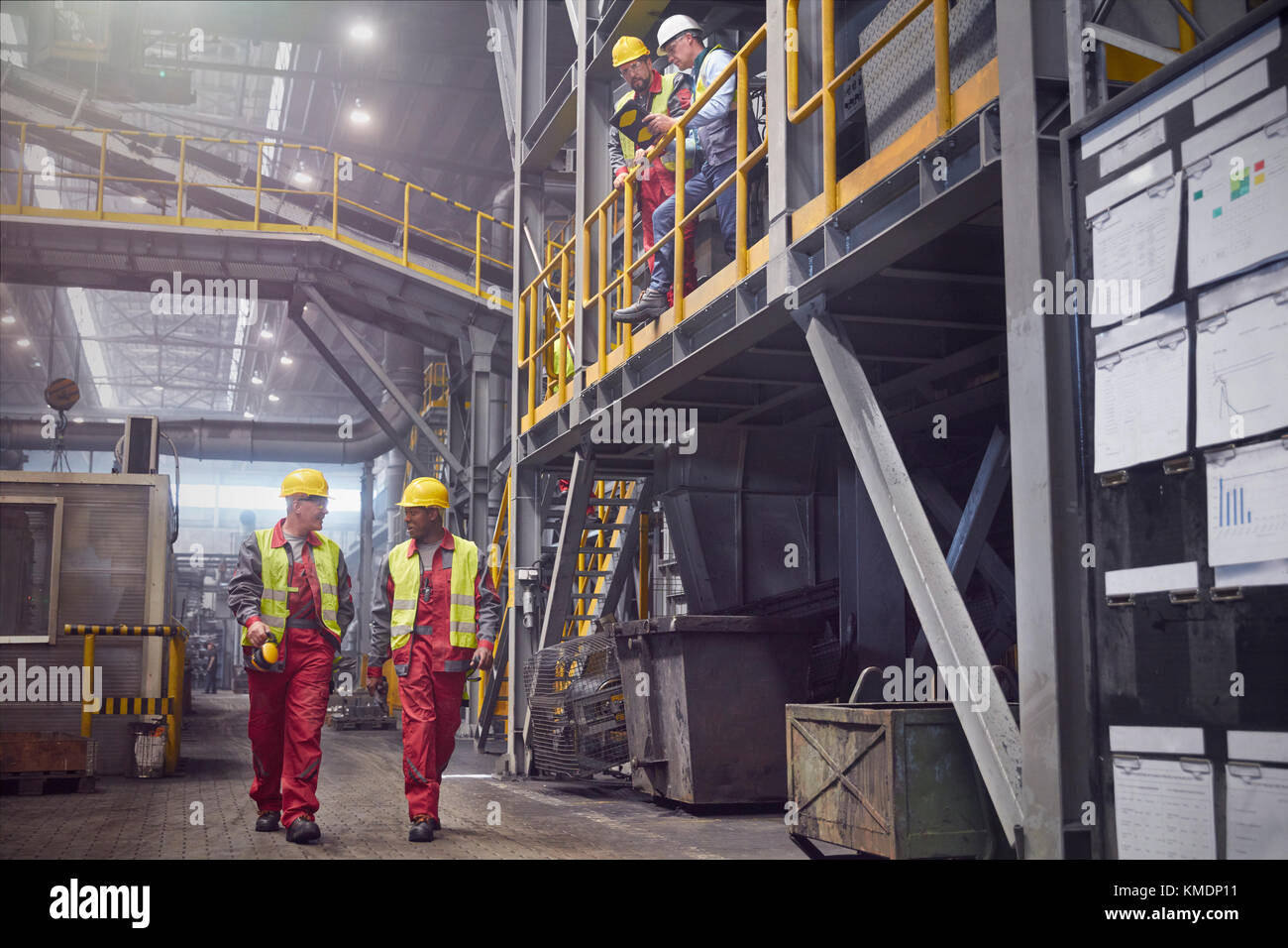 Steelworkers walking in steel mill Stock Photo - Alamy
