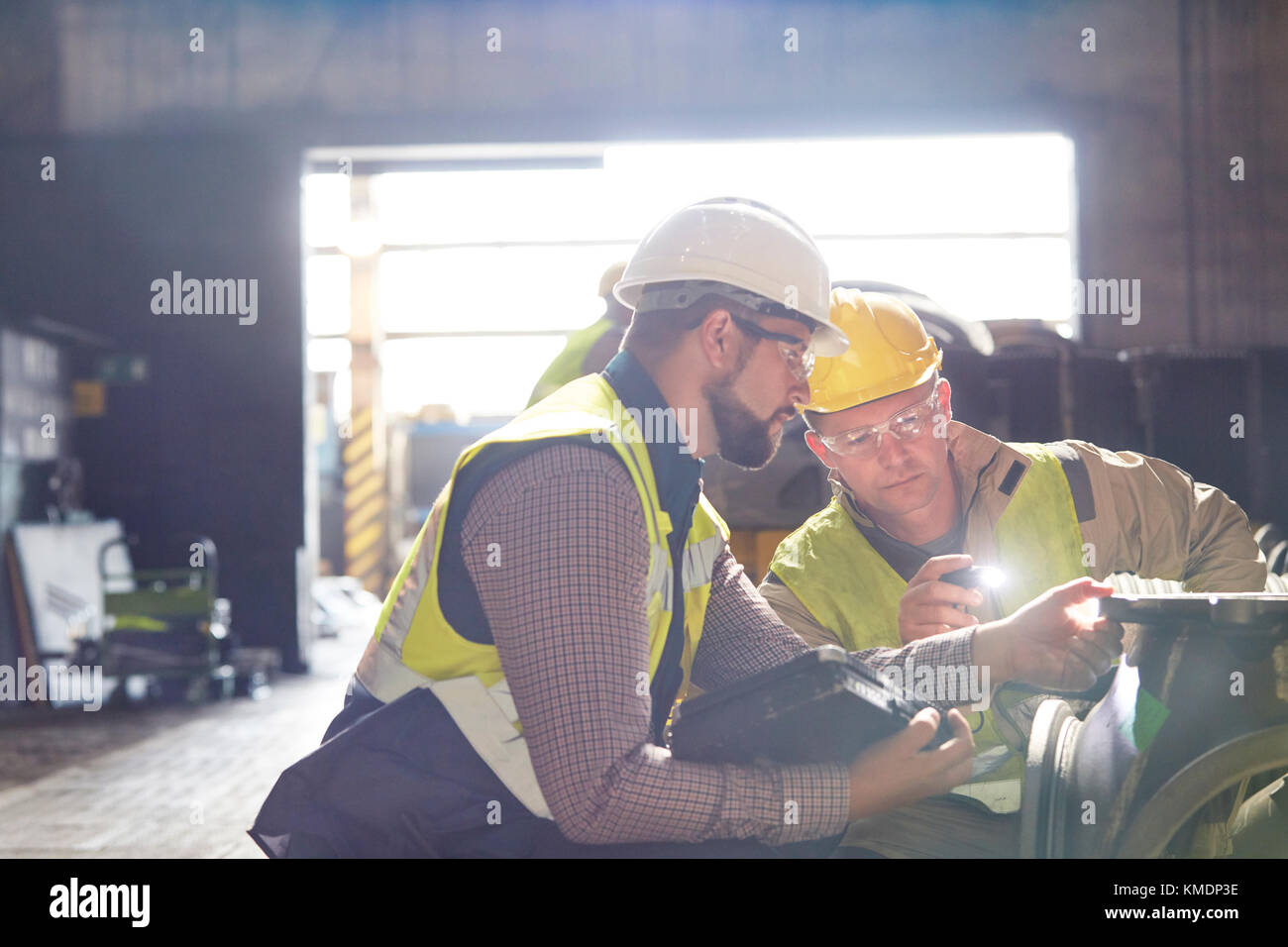 Steelworkers examining steel part in steel mill Stock Photo - Alamy