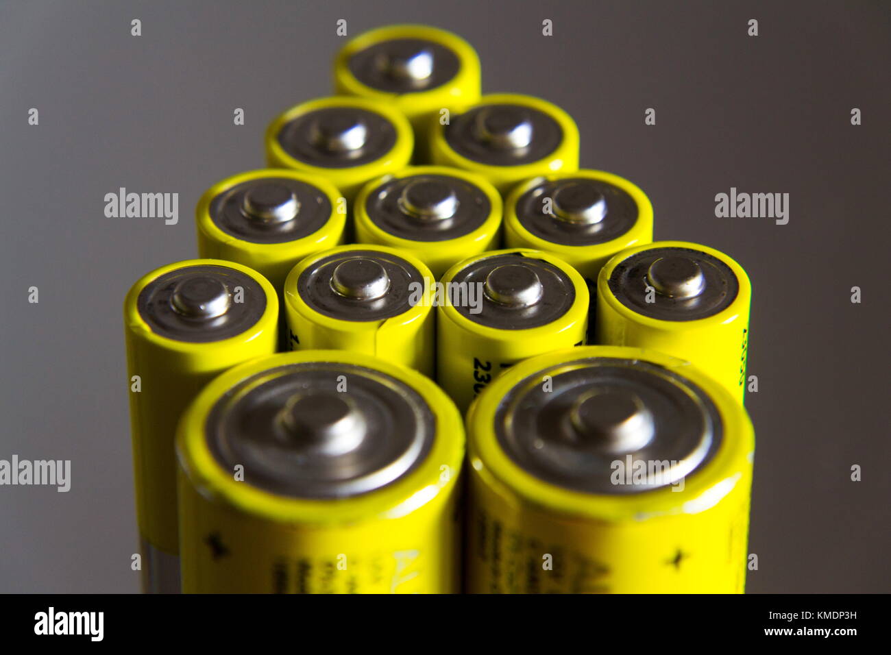 Stack of yellow AA batteries close up, electricity storage concept ...