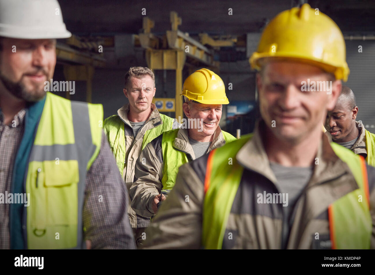 Steelworkers walking in steel mill Stock Photo - Alamy