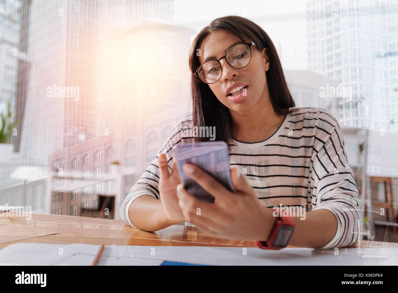 Serious brunette girl typing message Stock Photo - Alamy