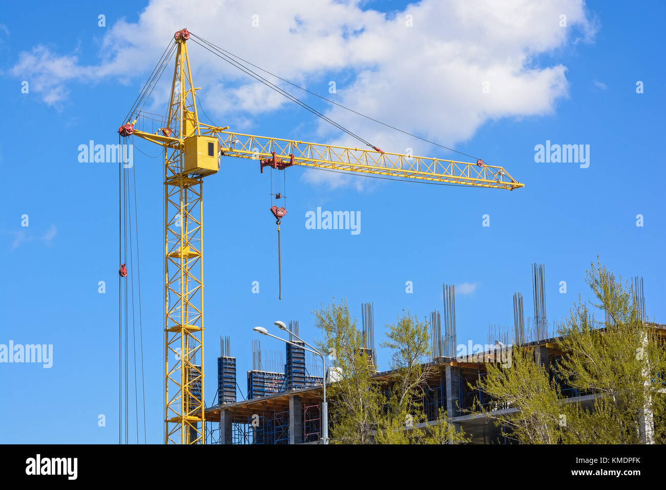 Construction crane builds new building Stock Photo - Alamy