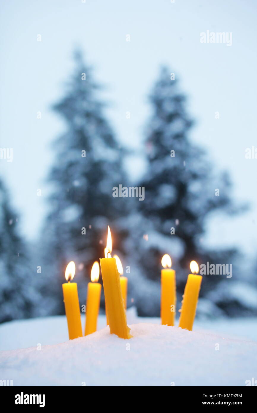 Yellow Candles In Snow Stock Photo - Alamy
