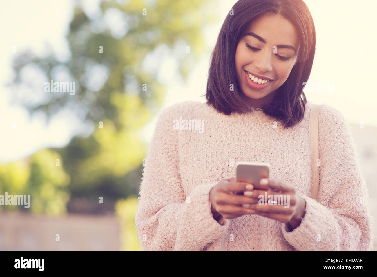 Cheerful pleasant woman typing a message Stock Photo - Alamy