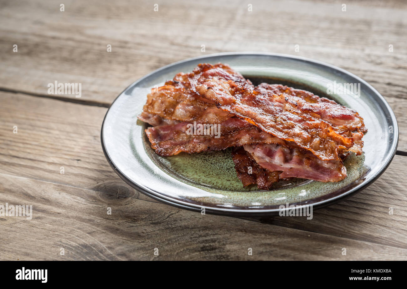 Stack of fried bacon strips on the plate Stock Photo - Alamy