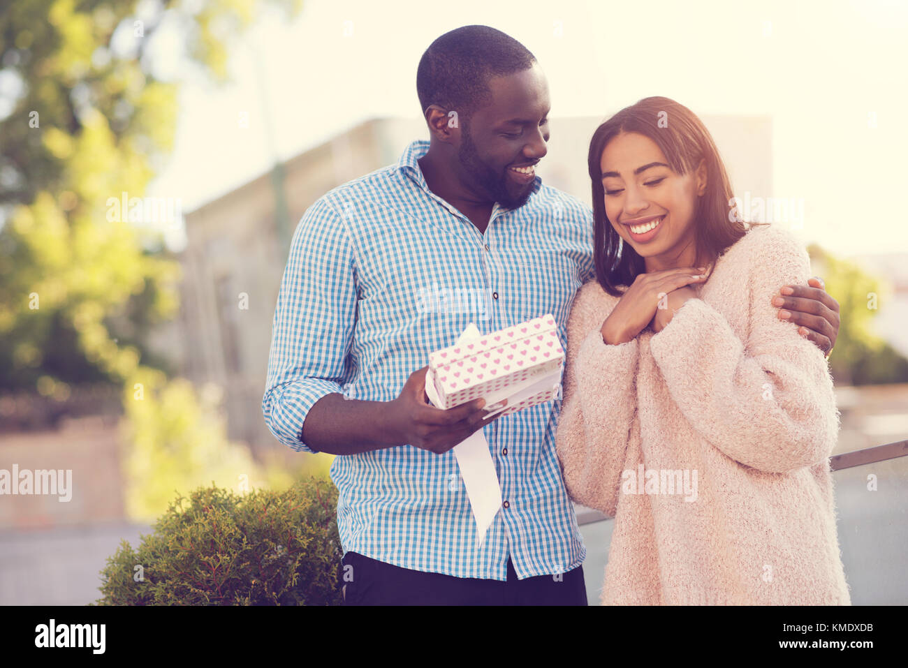 Nice young woman being happy about a present Stock Photo - Alamy