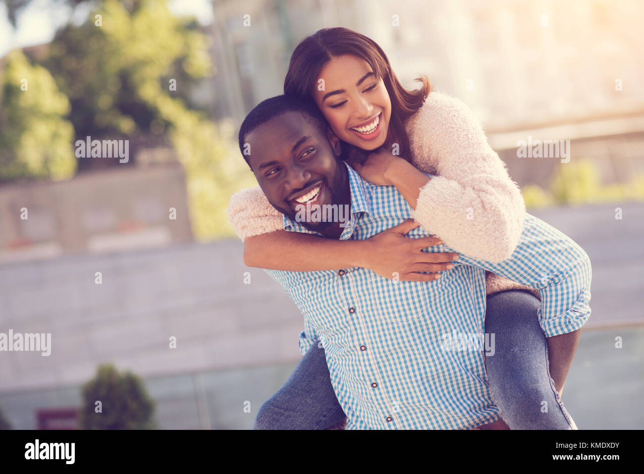 Joyful strong man holding his girlfriend Stock Photo - Alamy