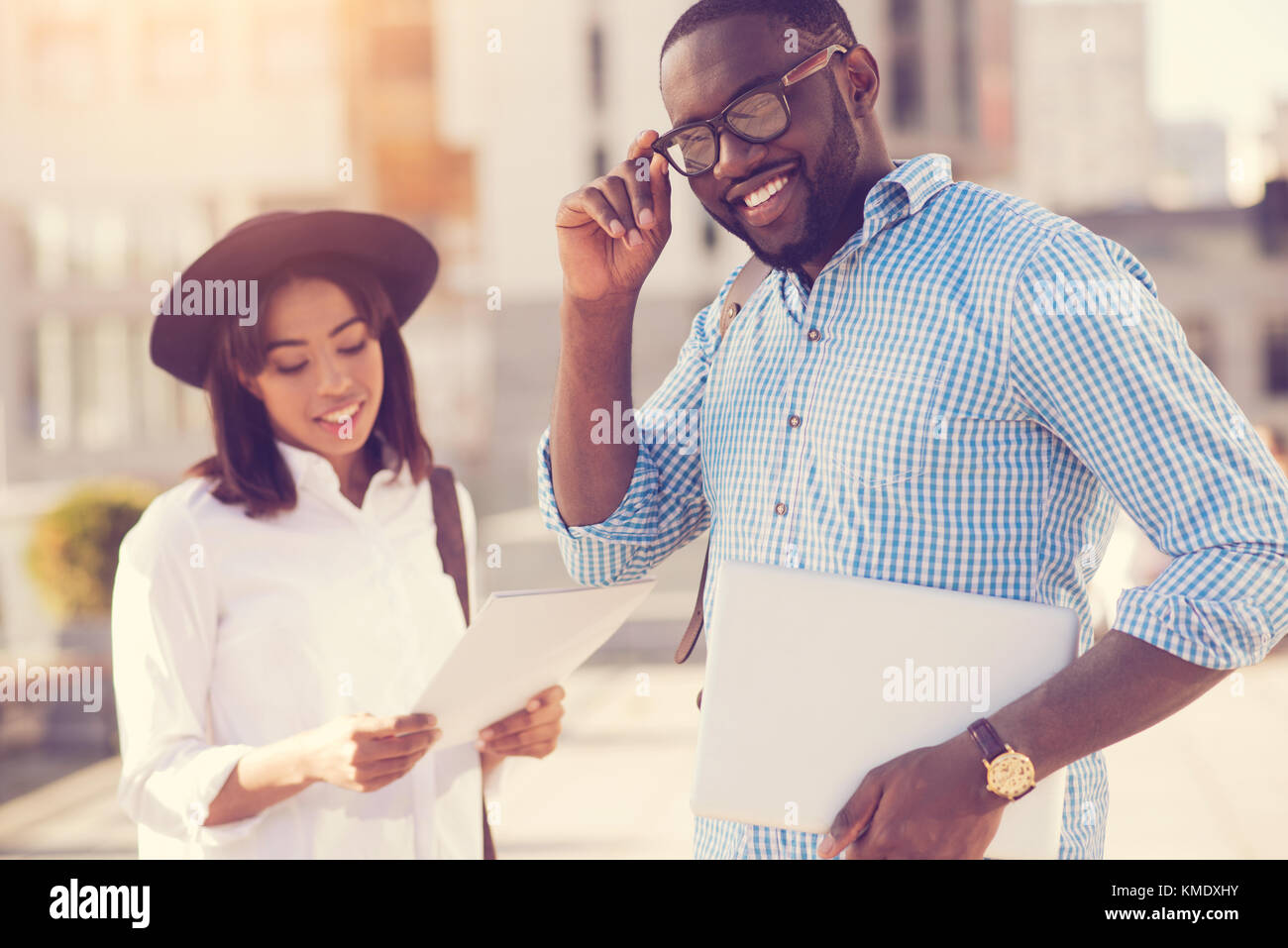 Handsome intelligent man fixing his glasses Stock Photo - Alamy