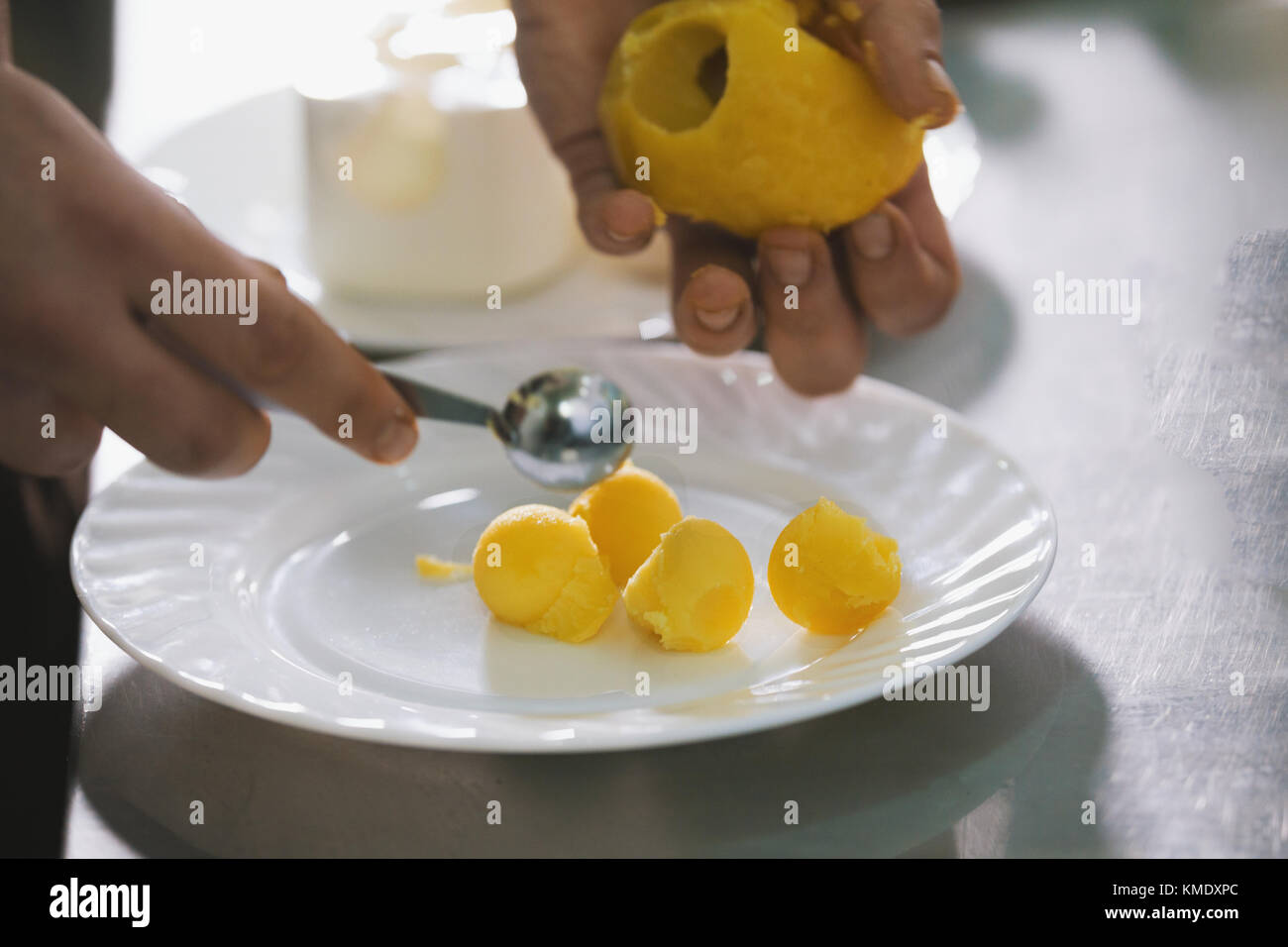 Chef makes potato balls for salad in commercial kitchen Stock Photo - Alamy
