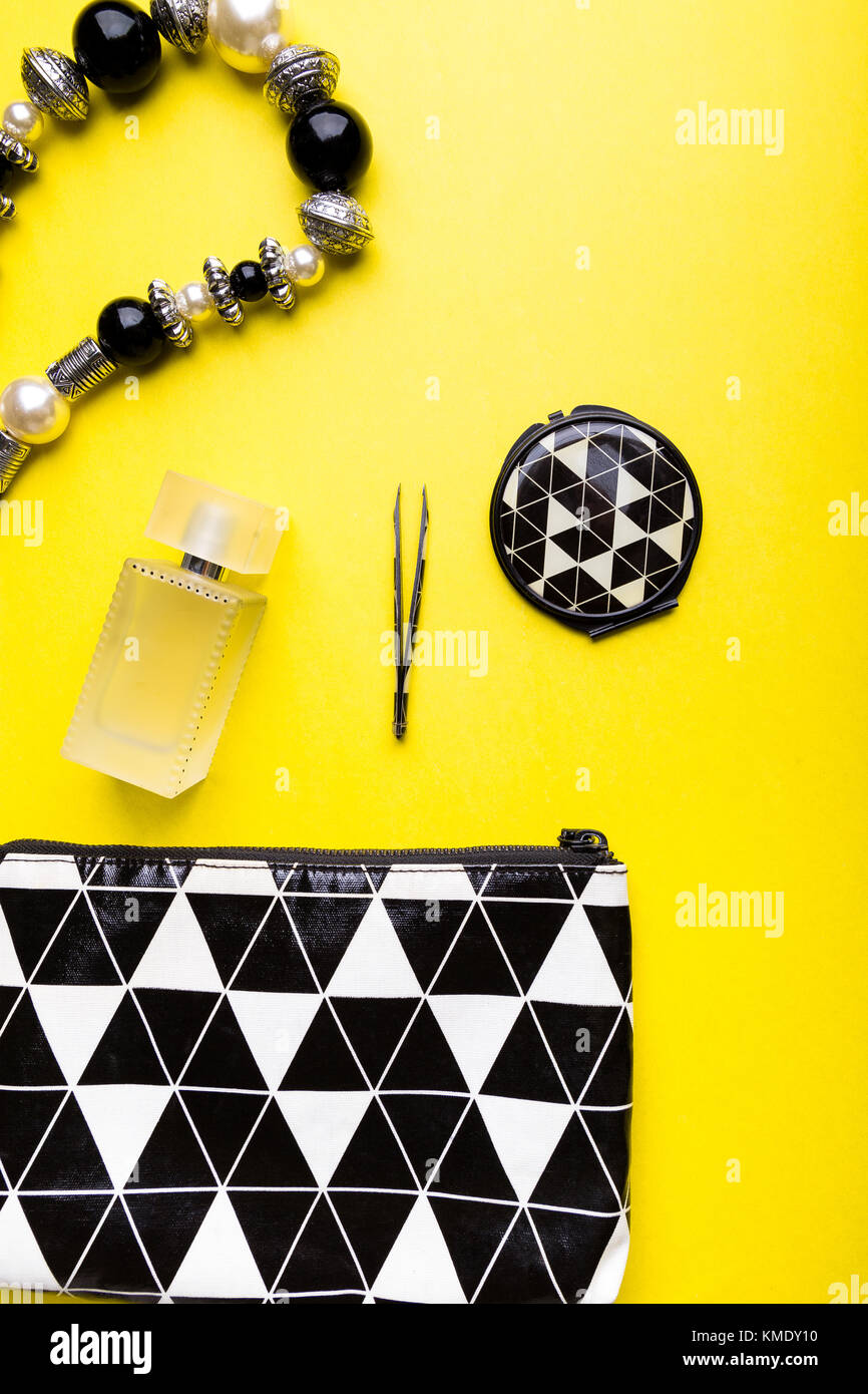 Woman handbag with makeup and accessories on yellow background. Flat ...