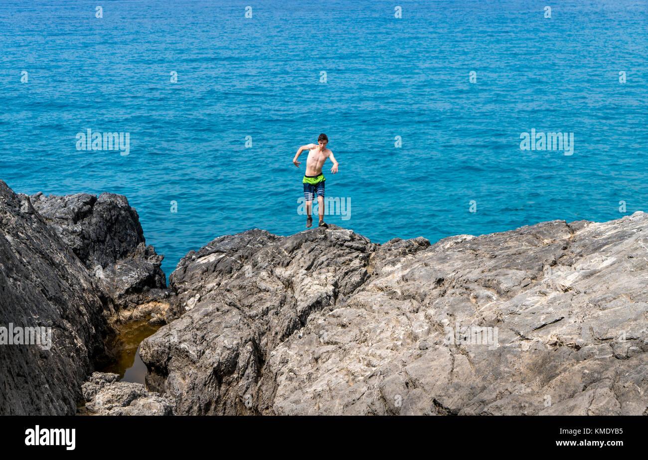young man on a cliff getting out of balance Stock Photo - Alamy