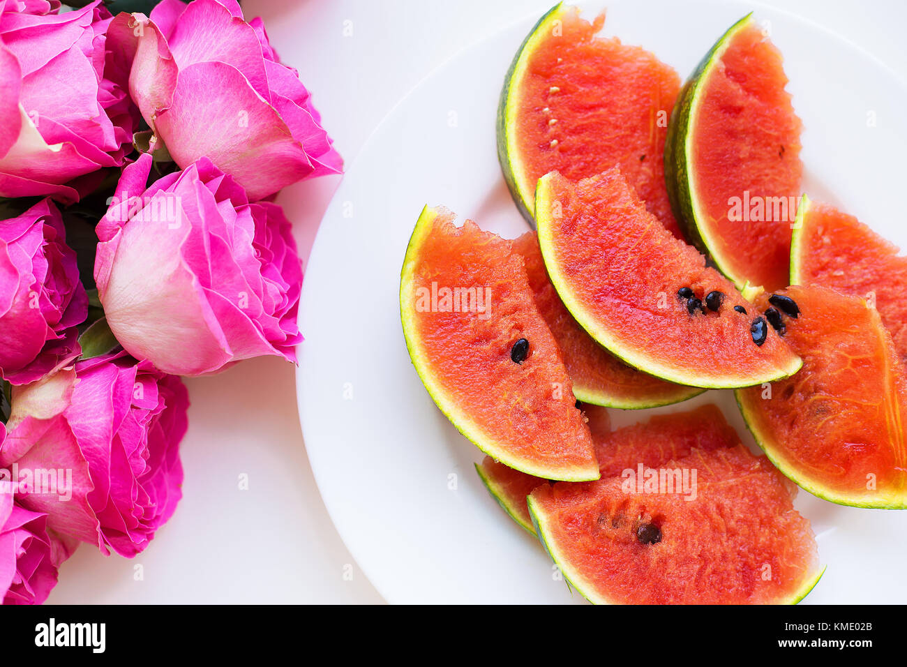 bouquet of pink roses on the table with watermelon Stock Photo - Alamy