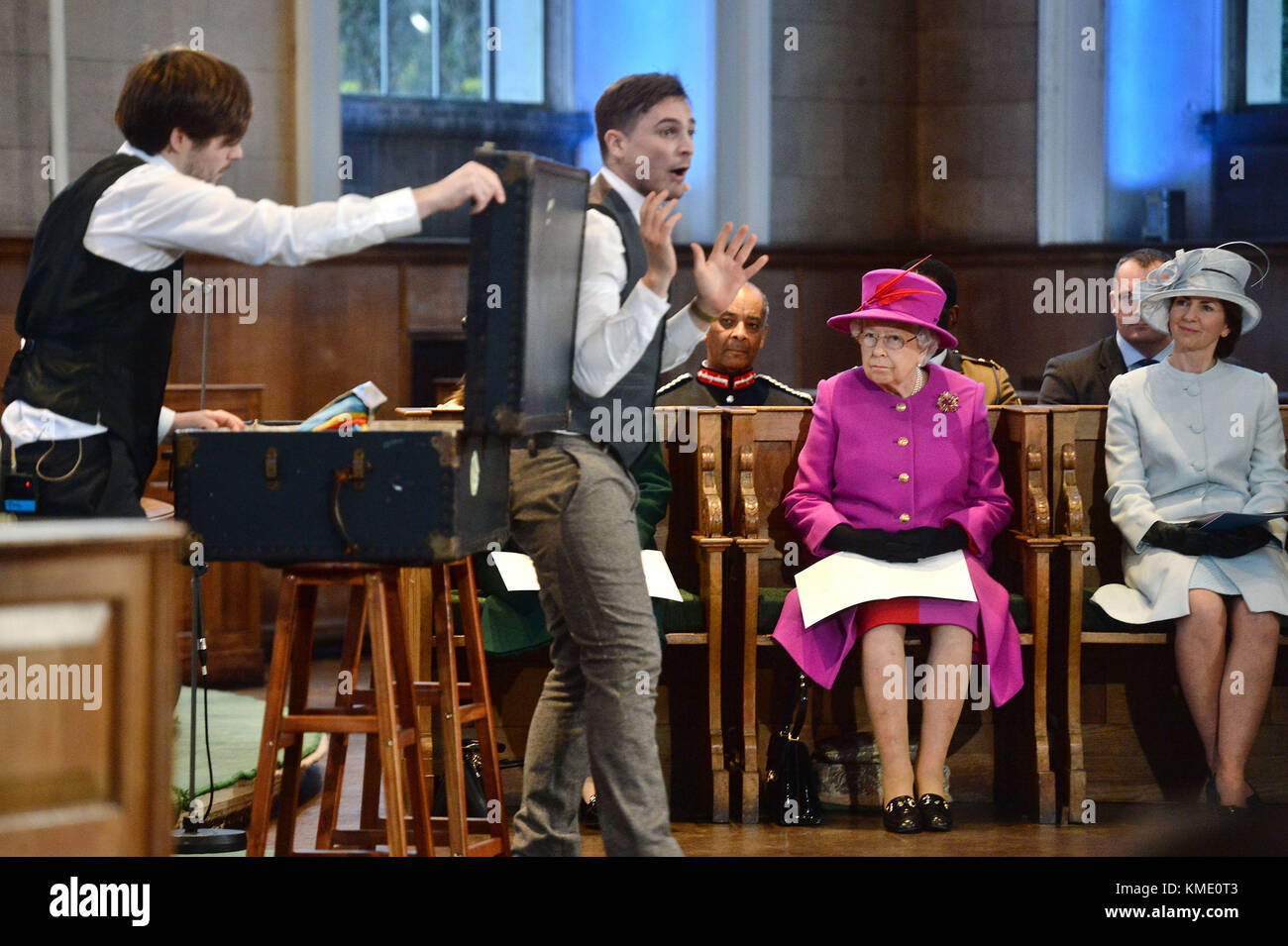 Queen Elizabeth II watches a performance by the Artless Theatre Company ...