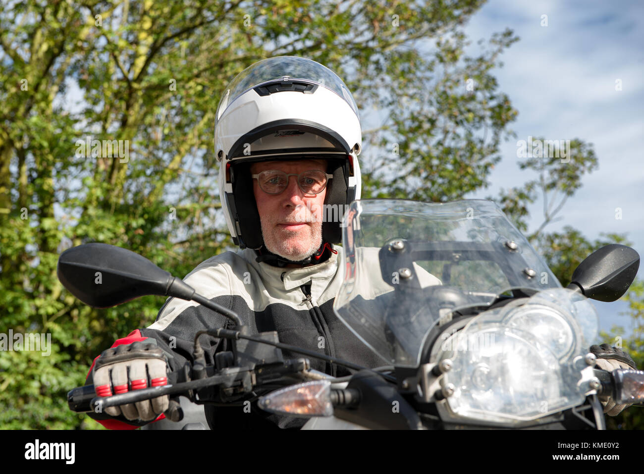 a portrait of a senior biker on his motorcycle Stock Photo - Alamy