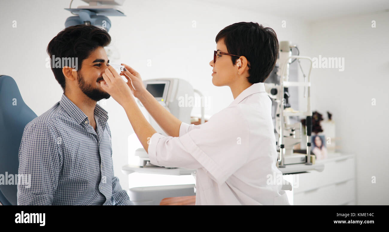 Optometrist examining patient in modern ophthalmology clinic Stock ...