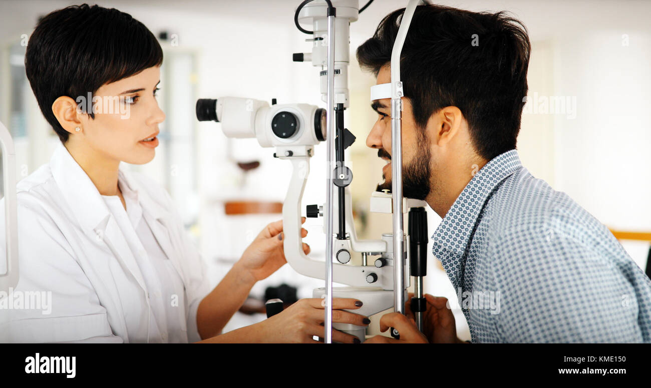Optometrist examining patient in modern ophthalmology clinic Stock ...