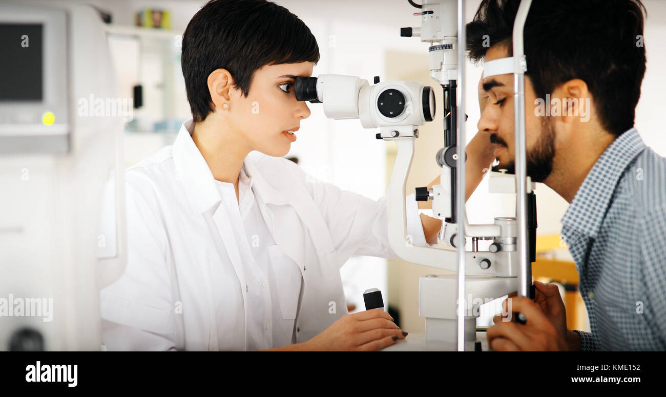 Woman doing eye test with optometrist in eye sight clinic Stock Photo ...