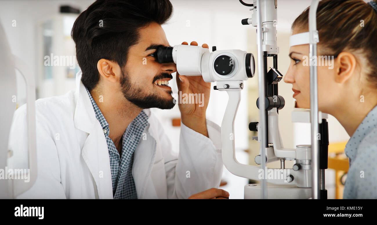 Patient or customer at slit lamp at optometrist or optician Stock Photo ...