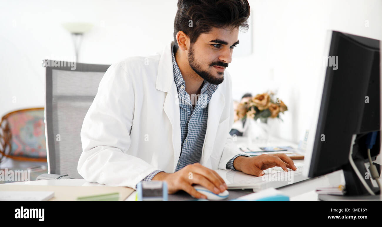 Doctor typing and using his computer Stock Photo - Alamy