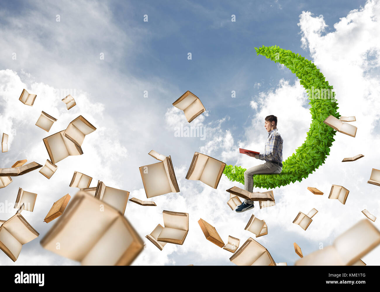 Man reading book and many of them flying in air Stock Photo - Alamy