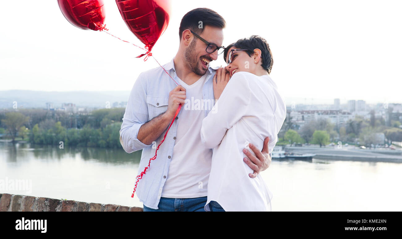 Couple in love cuddling while enjoying beautiful urban sunset together ...