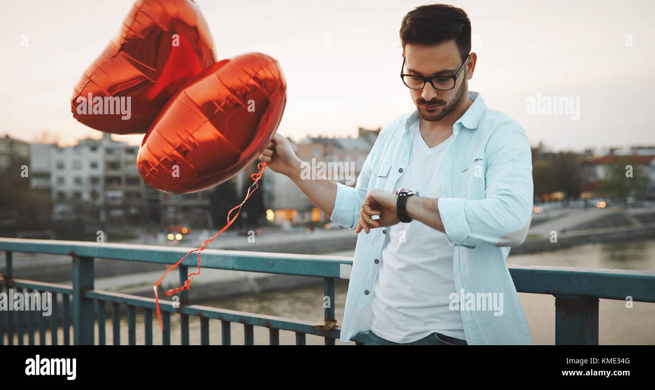 Sad man waiting for date on valentine date Stock Photo - Alamy
