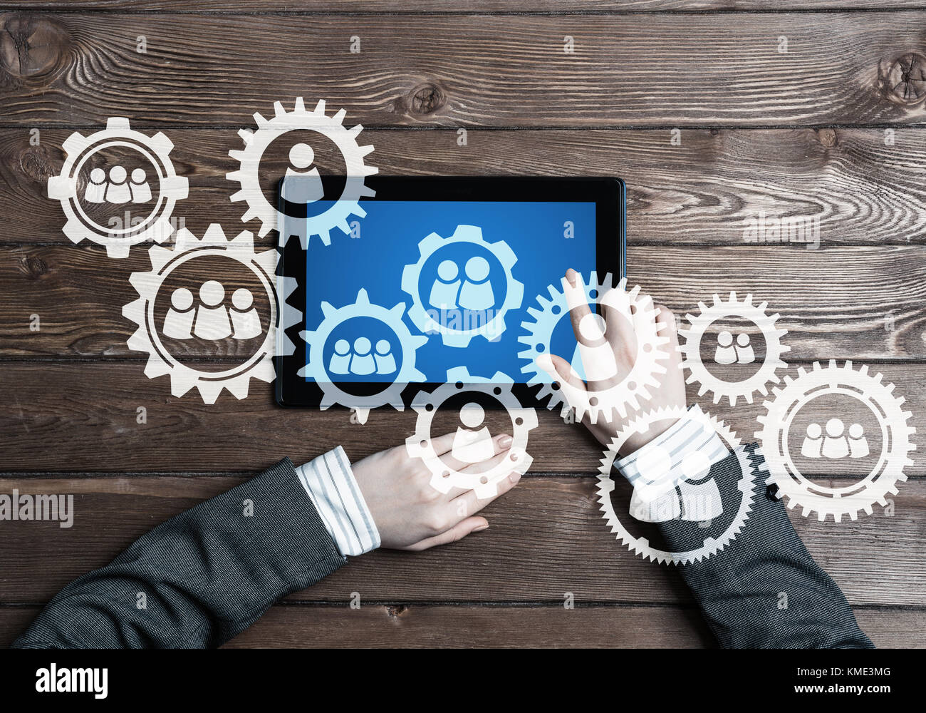 Concept of teamworking and connection with gears mechanism and tablet ...