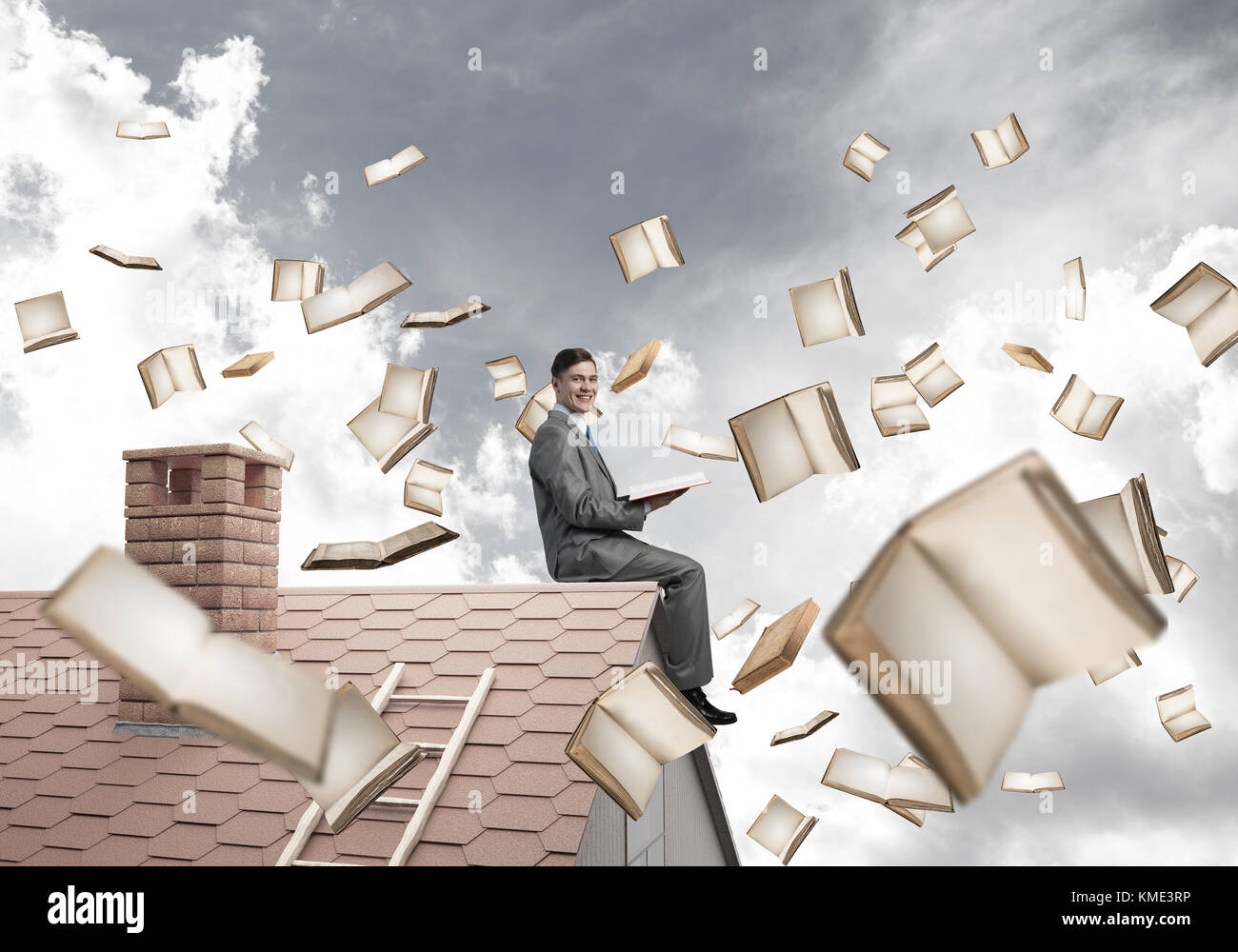Man reading book and many of them flying in air Stock Photo - Alamy